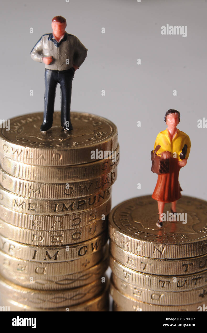 Plastic models of man woman stand on pile of coins hi-res stock ...