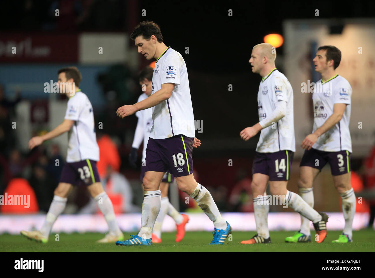 Everton's Gareth Barry (centre) walks back to the centre circle ...