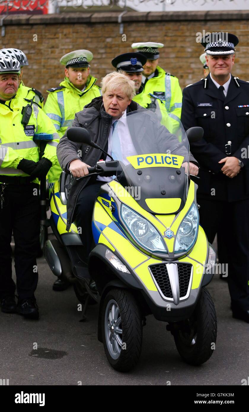 Mayor of London Boris Johnson sits on a police motorcycle as he meets ...