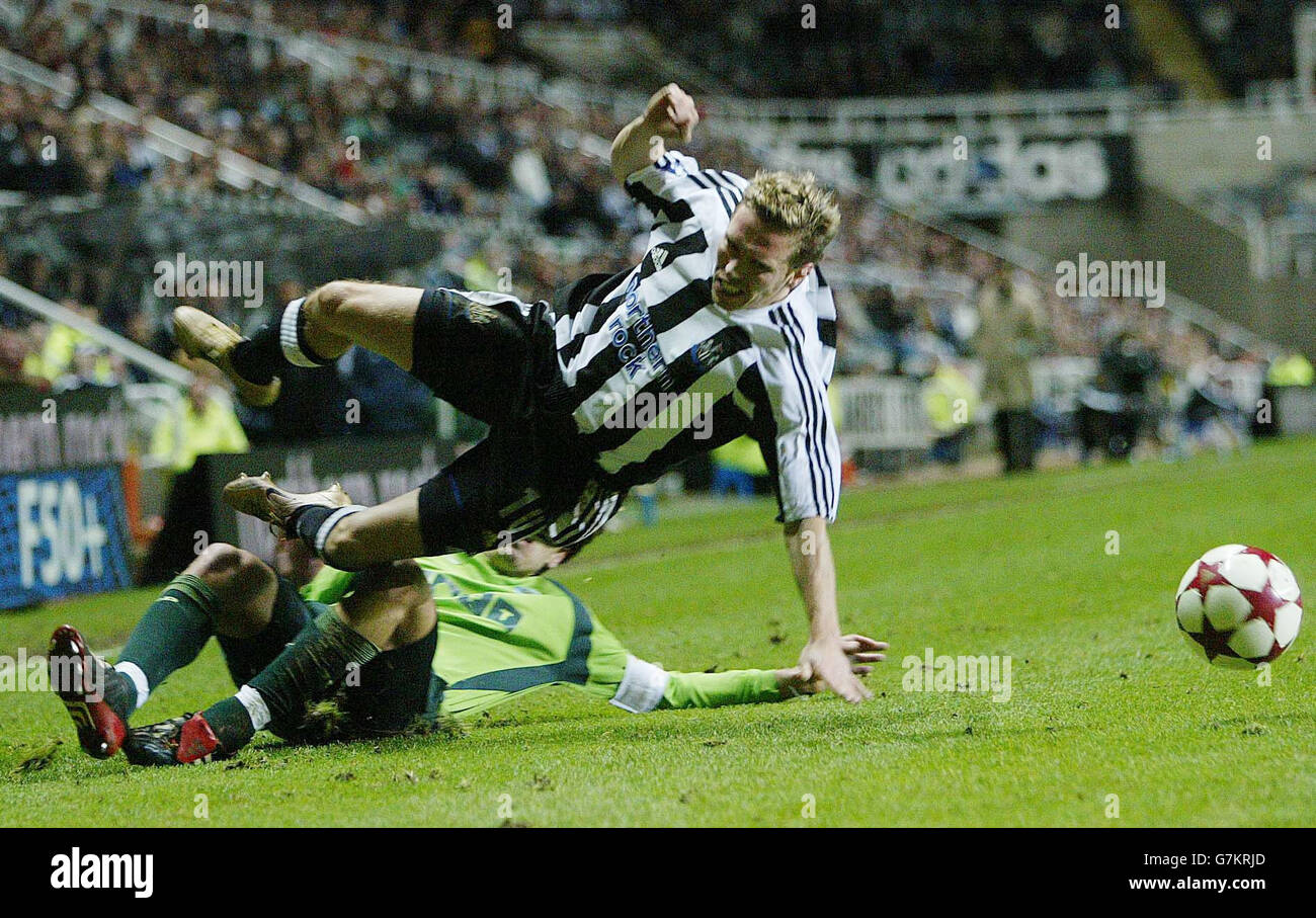Newcastle's Craig Bellamy is fouled by Sporting Lisbon's Anderson Polga ...