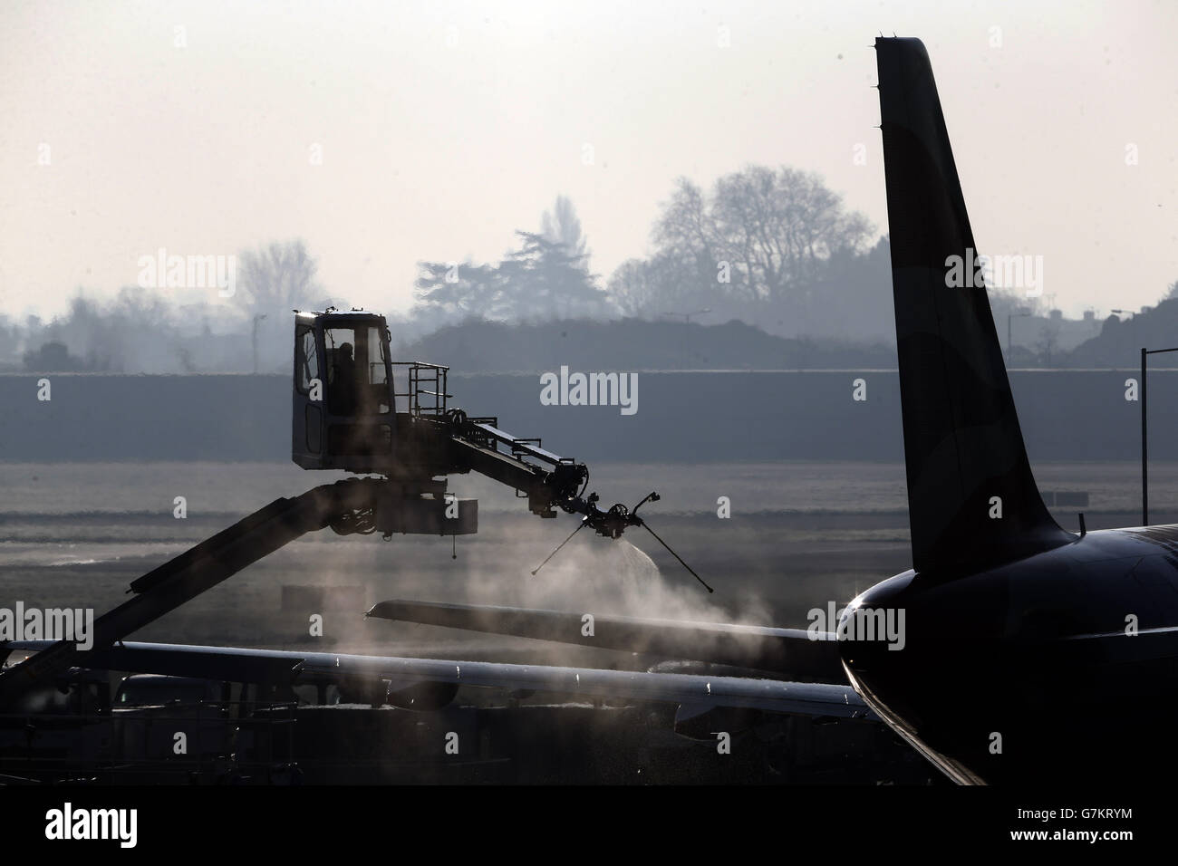 A British Airways plane is de-iced before its departure at Heathrow ...