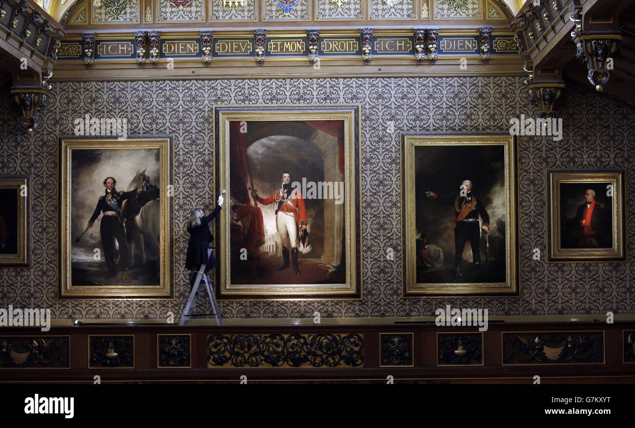 A member of staff from the Royal Collection Trust applies some ...