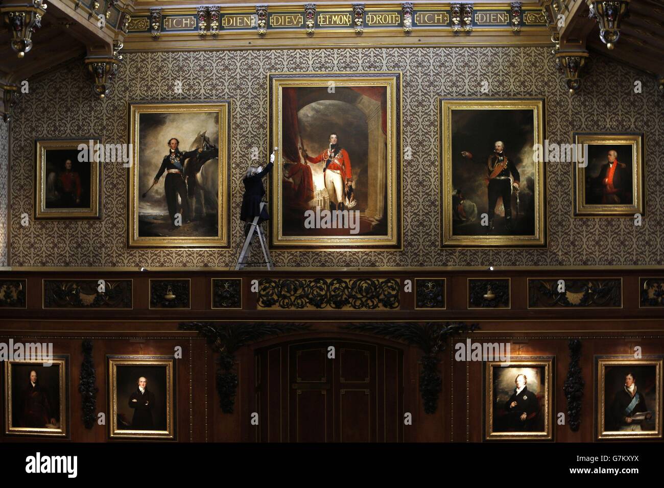 A member of staff from the Royal Collection Trust applies some ...