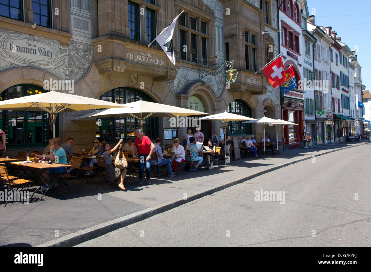 Sidewalk cafes, pubs and bars line Barfusserplatz in Basel, Switzerland ...
