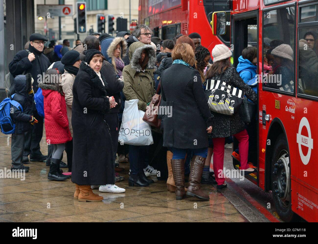Commuters queue to get onto a bus outside Vauxhall bus station, London ...