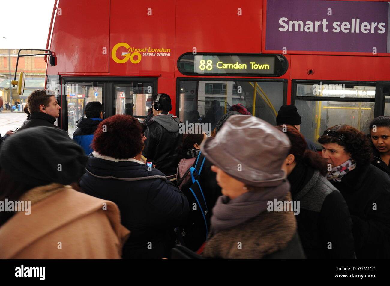 Commuters queue to get onto a bus outside Vauxhall bus station, London ...