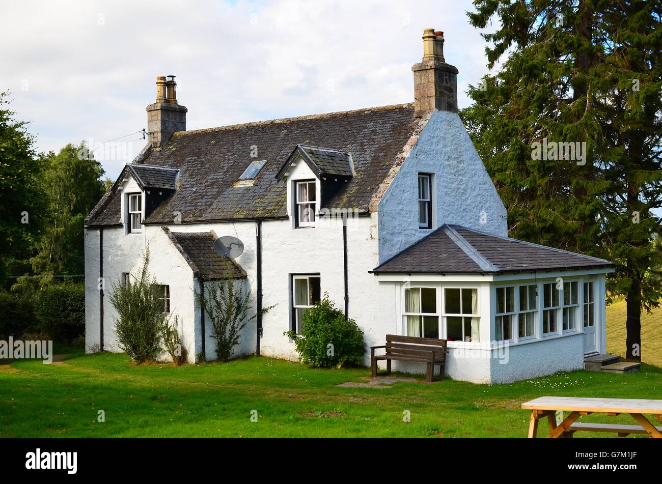 Typical Scottish cottage with weathered slate roof in the Cairngorms ...