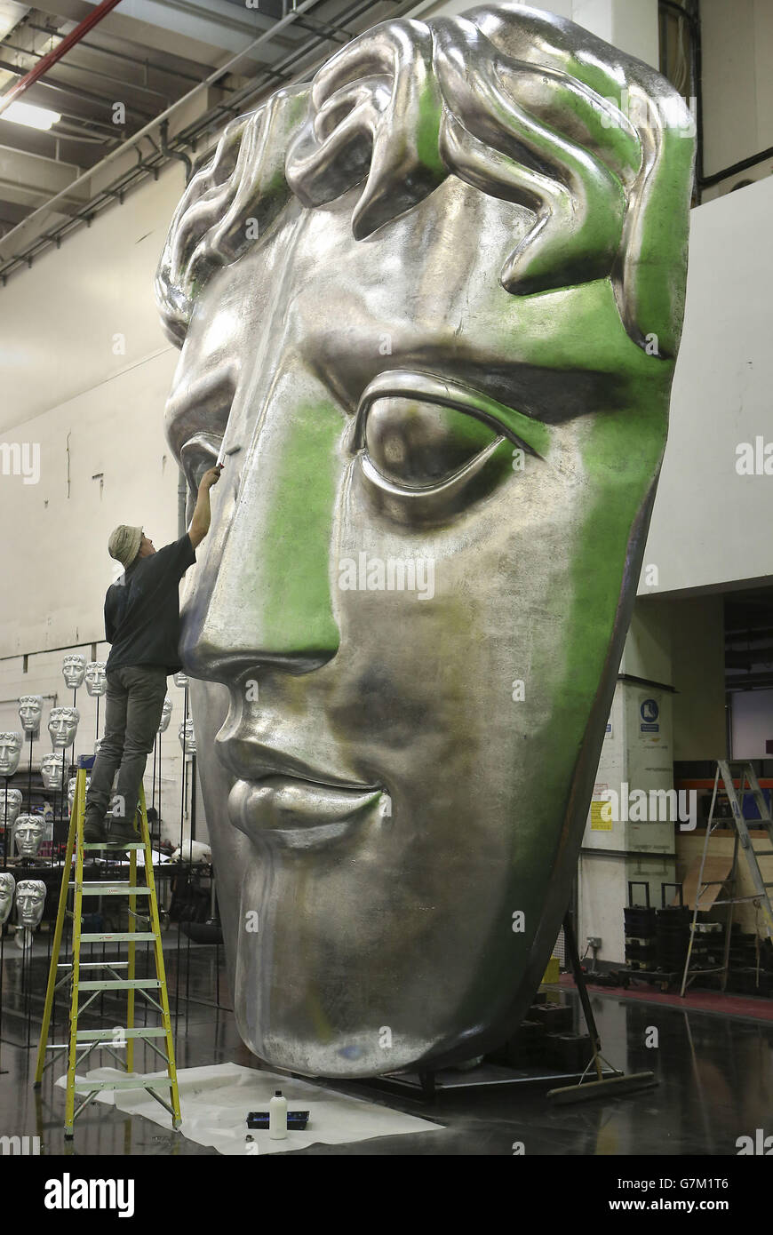 A workman painting part of the set at the Royal Opera House in London ...