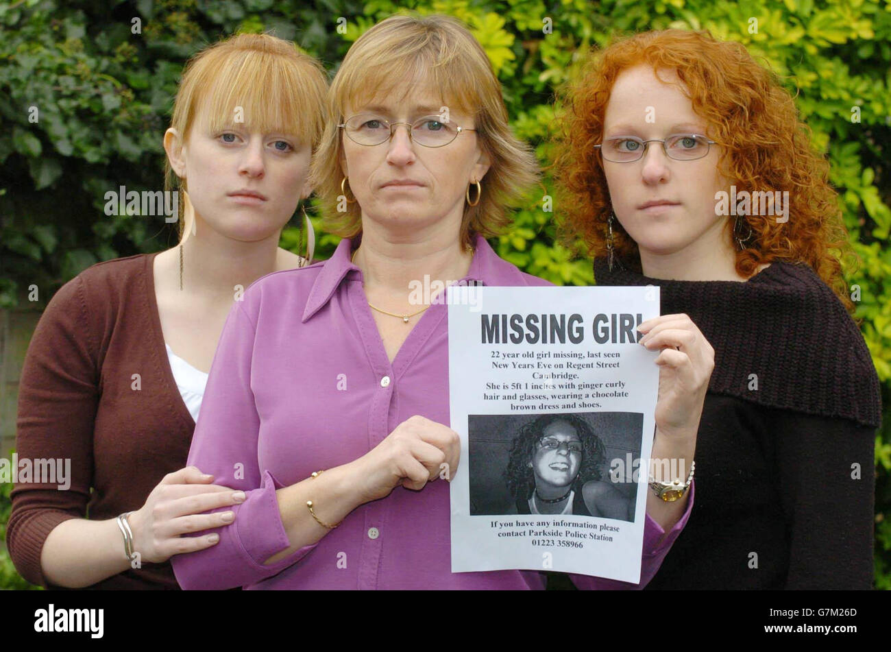 Sue Geeson [centre] holds a poster appealing for information about her ...