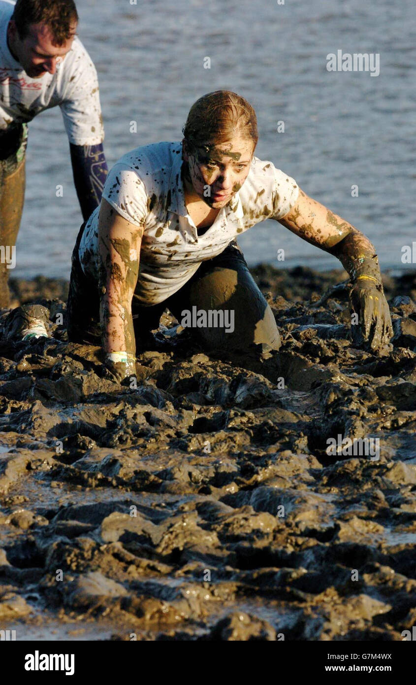 A woman competitor gets stuck in the mud Stock Photo - Alamy