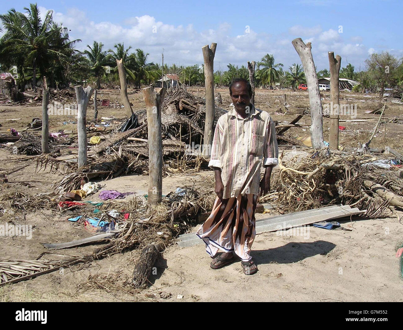 Lingeswaran Kassipillai, 40, stands in front of the ruins of his house ...