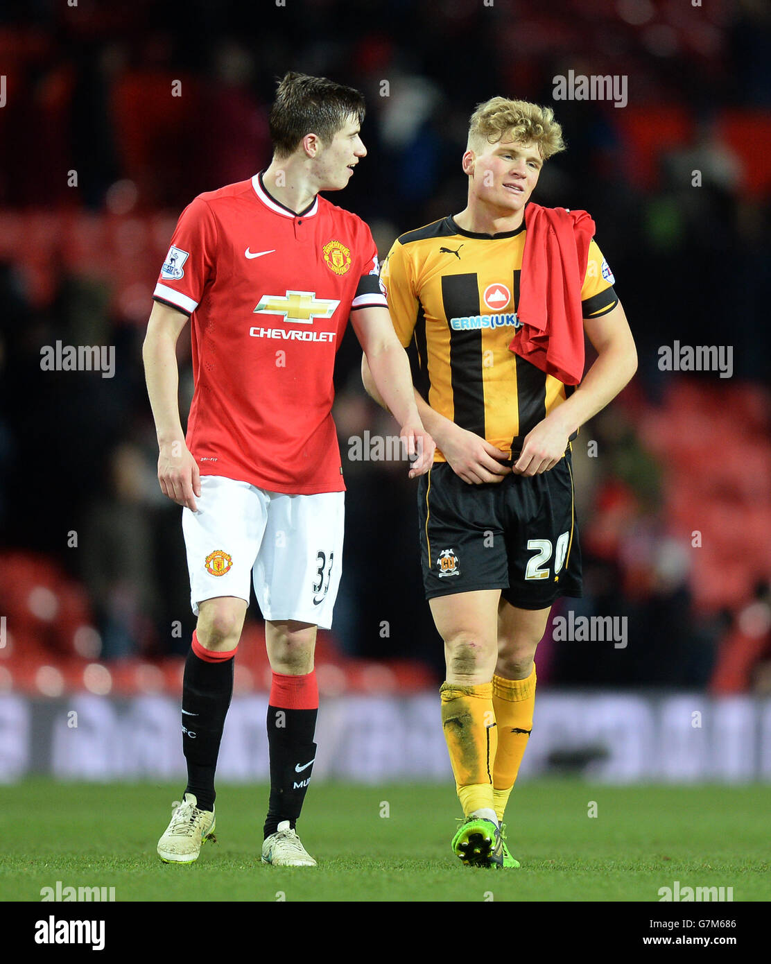 Manchester United's Paddy McNair (left) and Cambridge United's Richard ...