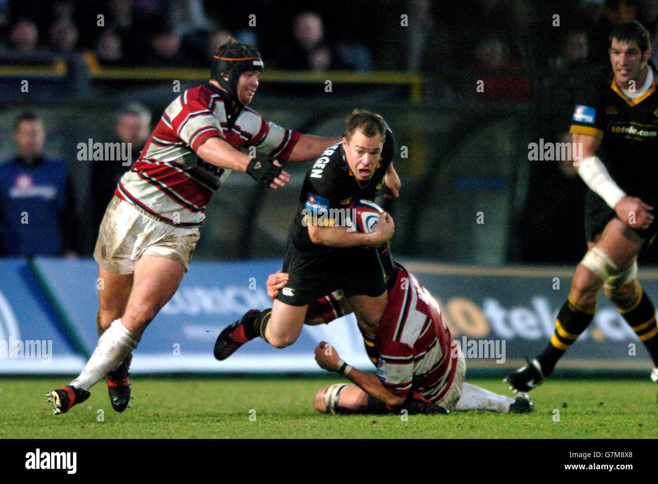 London Wasps' Mark van Gisbergen (c) is tackled by Gloucester's Jake ...