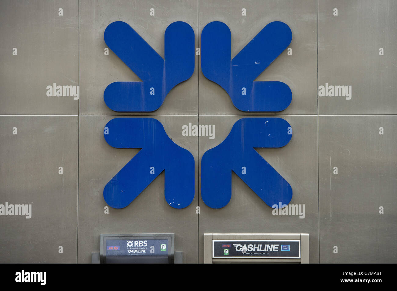 The logo of the Royal Bank of Scotland (RBS) hangs above two cash ...