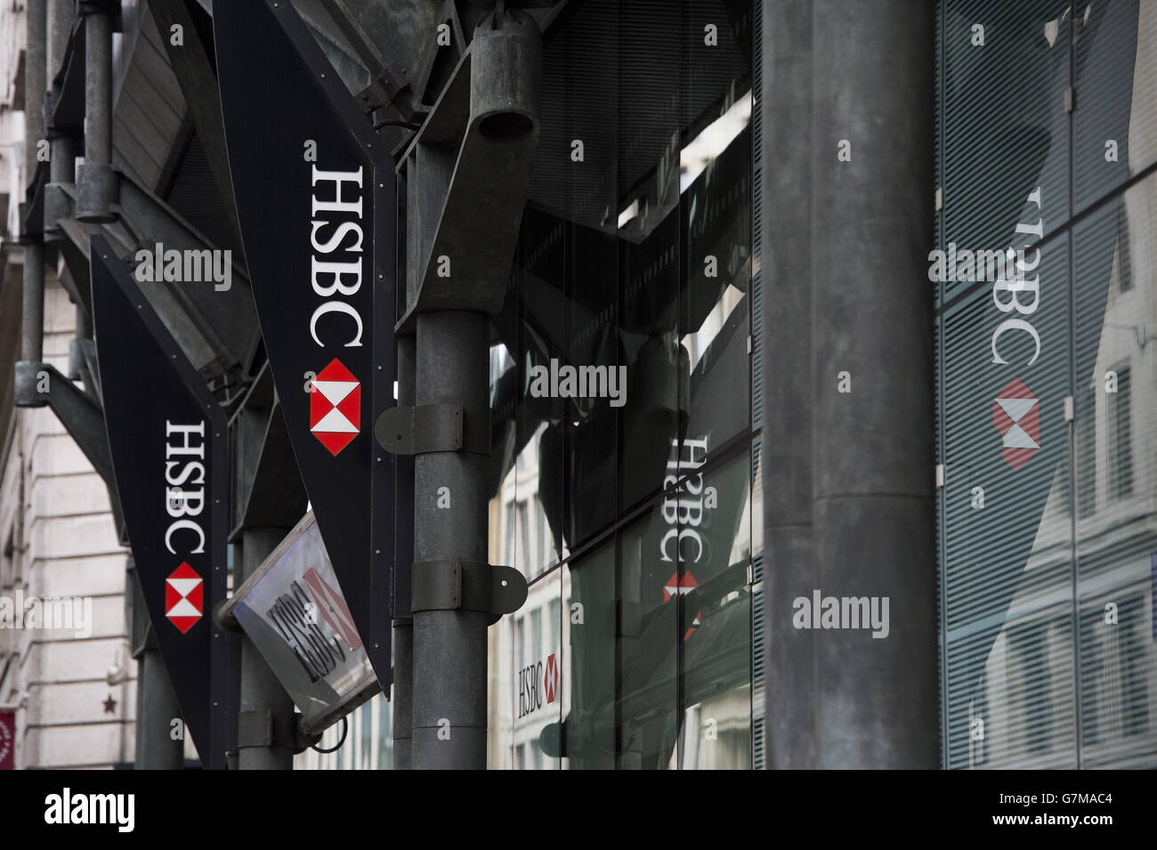 Hsbc signs are reflected in a branch window hi-res stock photography ...