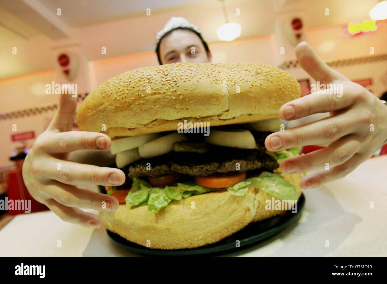 A diner in Eddie Rockets fast food restaurant, Dublin, prepares to tuck ...