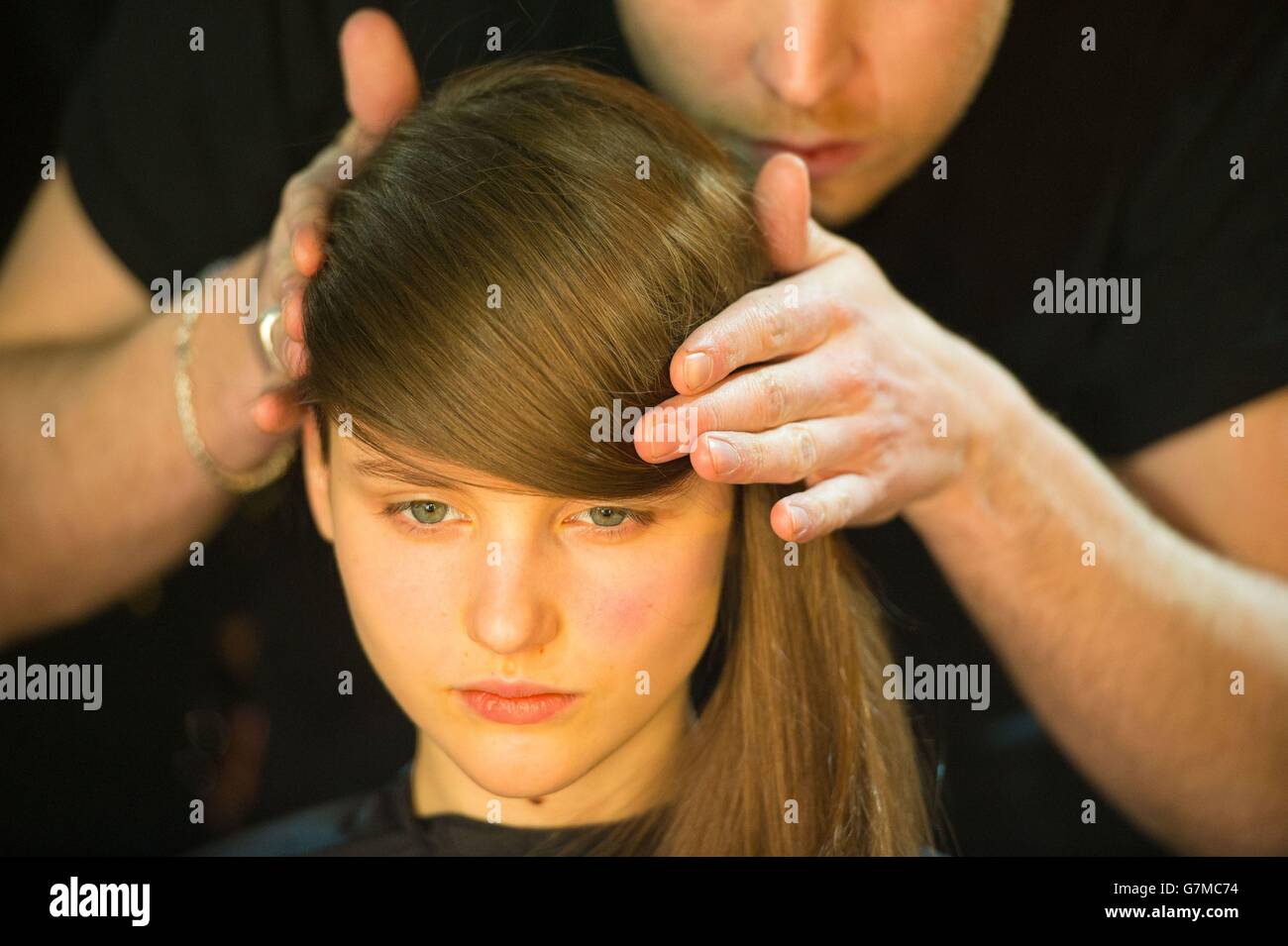 A model has her hair styled backstage before the Bora Aksu catwalk show ...