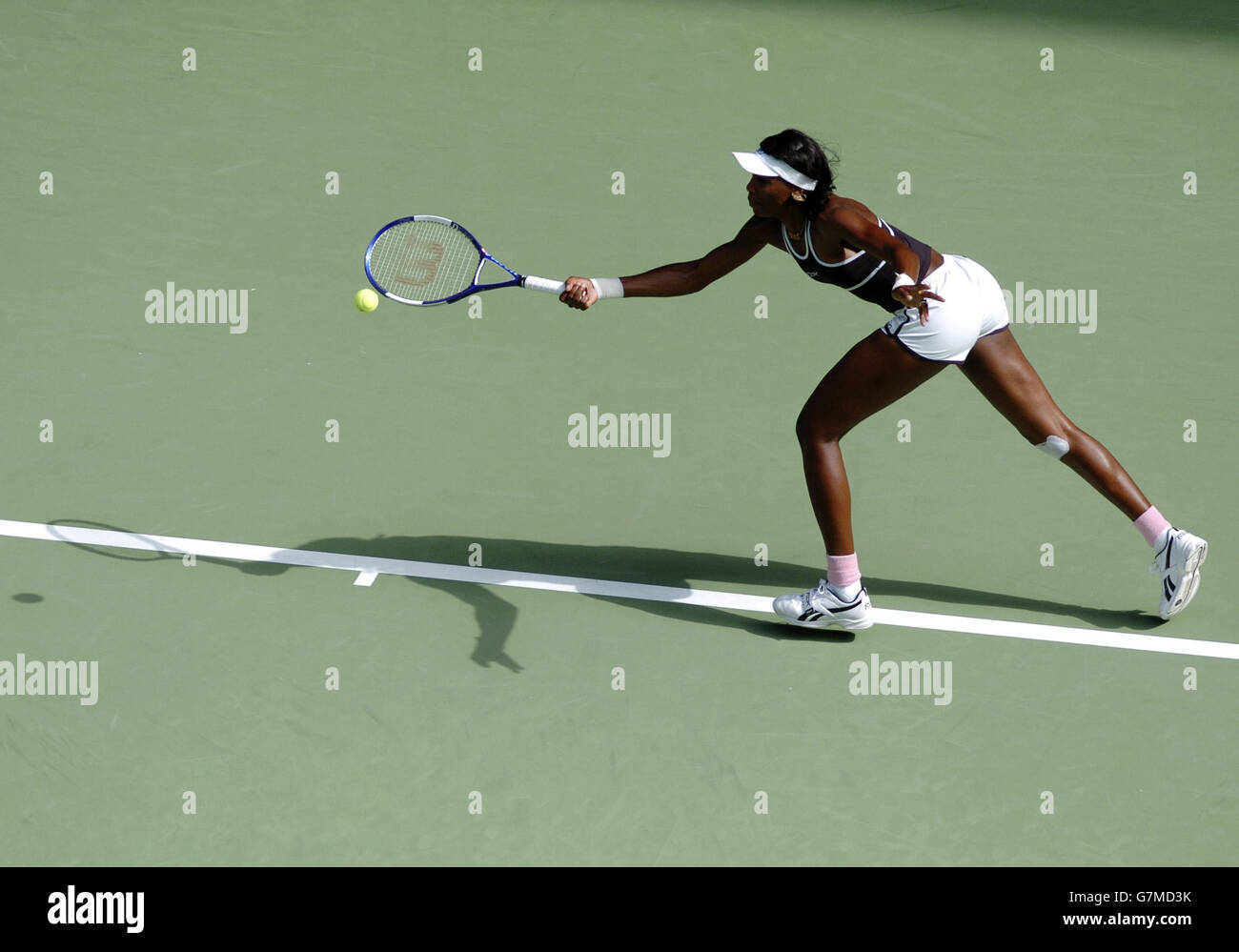 Venus Williams of USA reaches for a shot during her match against Shuai ...