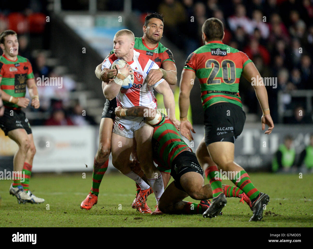 St Helens' Luke Thompson is tackled by South Sydney Rabbitohs' Greg ...