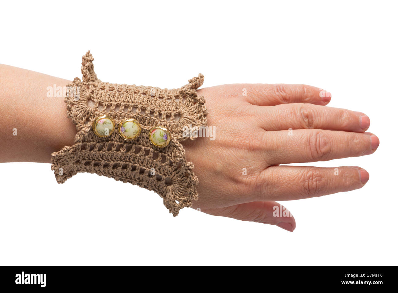 Brown handmade band with three bottoms on womans hand Stock Photo - Alamy