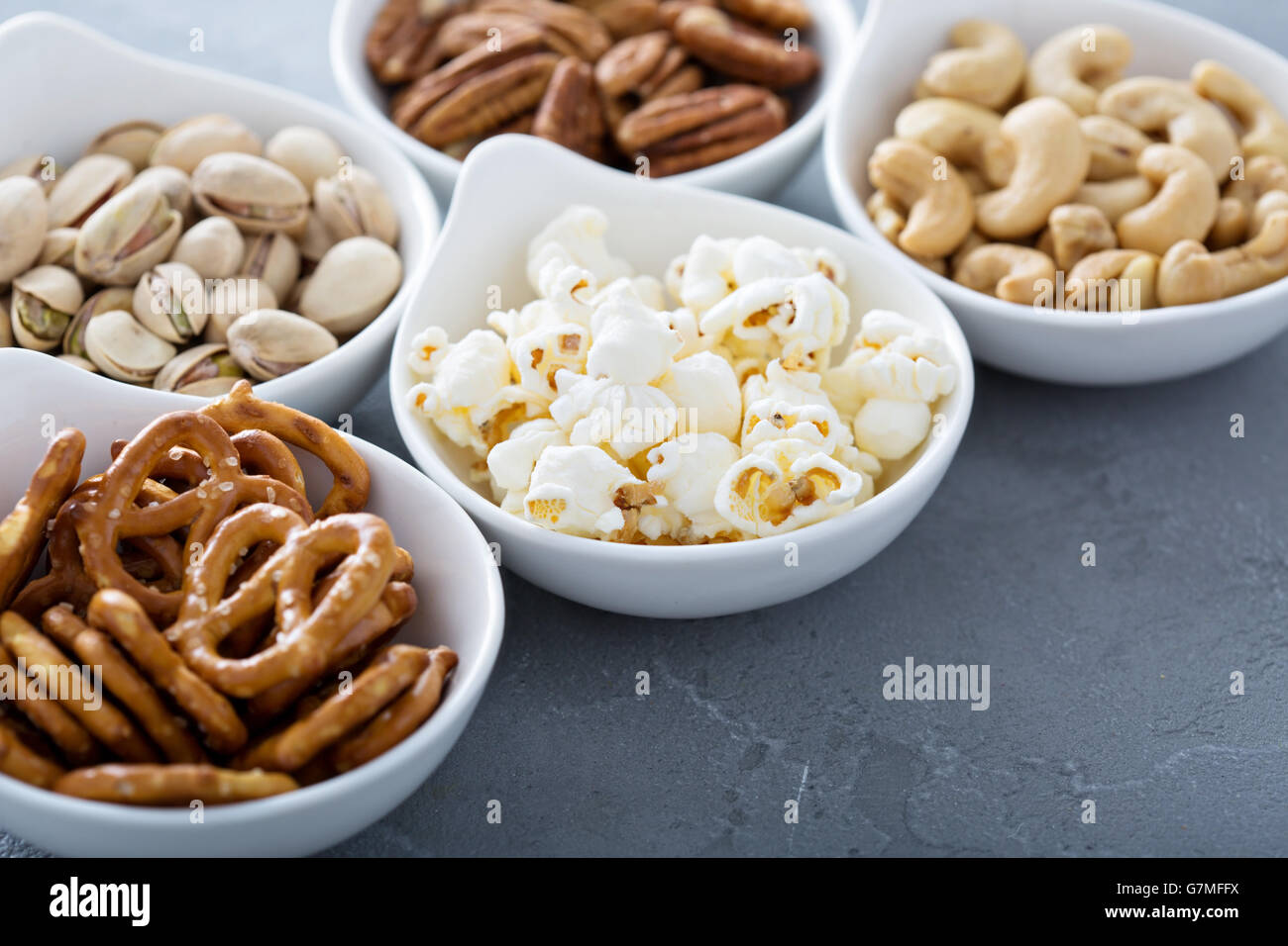 Variety of healthy snacks in white bowls Stock Photo - Alamy