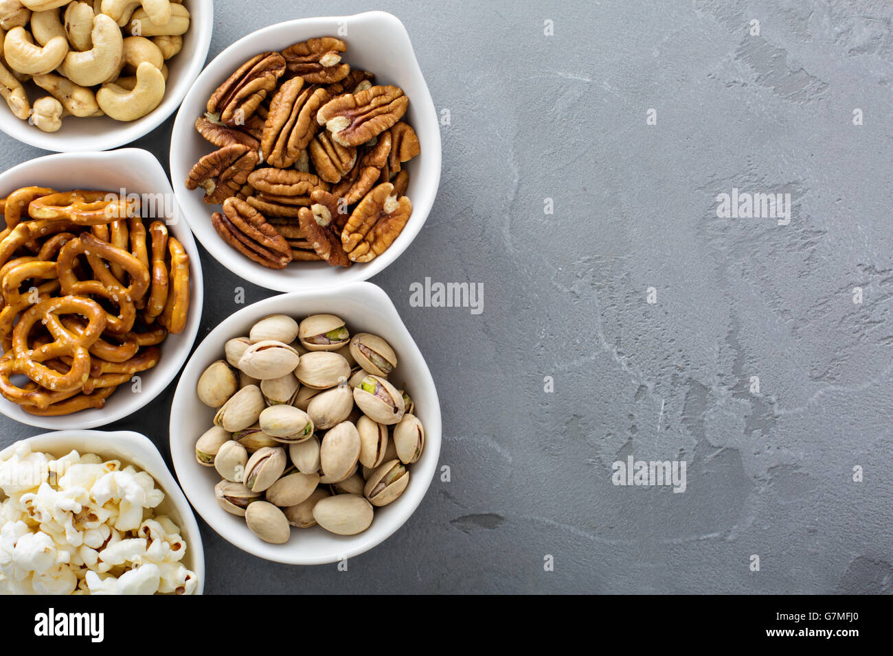 Variety of healthy snacks in white bowls Stock Photo - Alamy