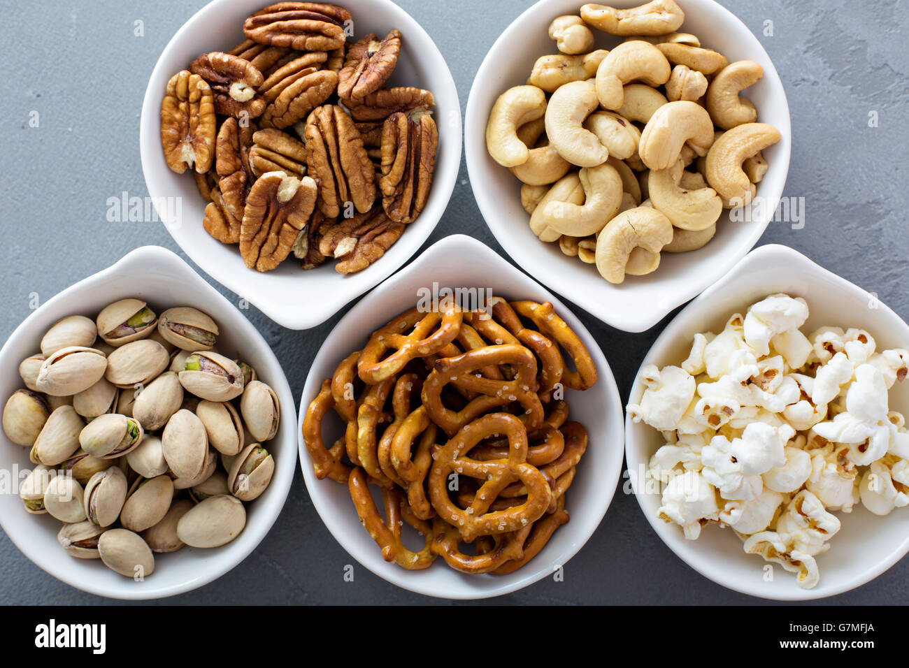 Variety of healthy snacks in white bowls Stock Photo - Alamy