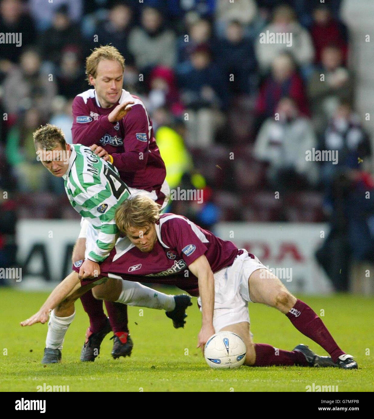 Neil MacFarlane (top) and Steven Pressley (right) of Hearts tussle with ...