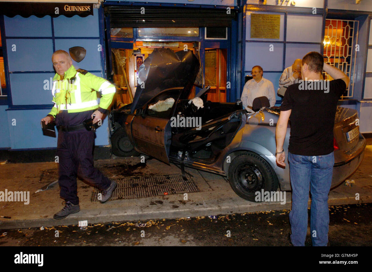 A Garda and members of the public view, an unmarked Garda car which ...