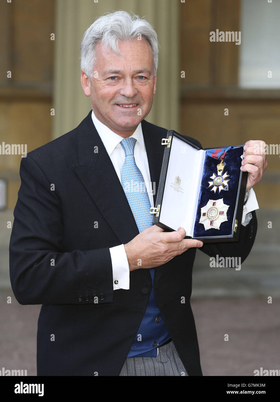 Sir Alan Duncan holding a medal presented to him by the Prince of Wales ...