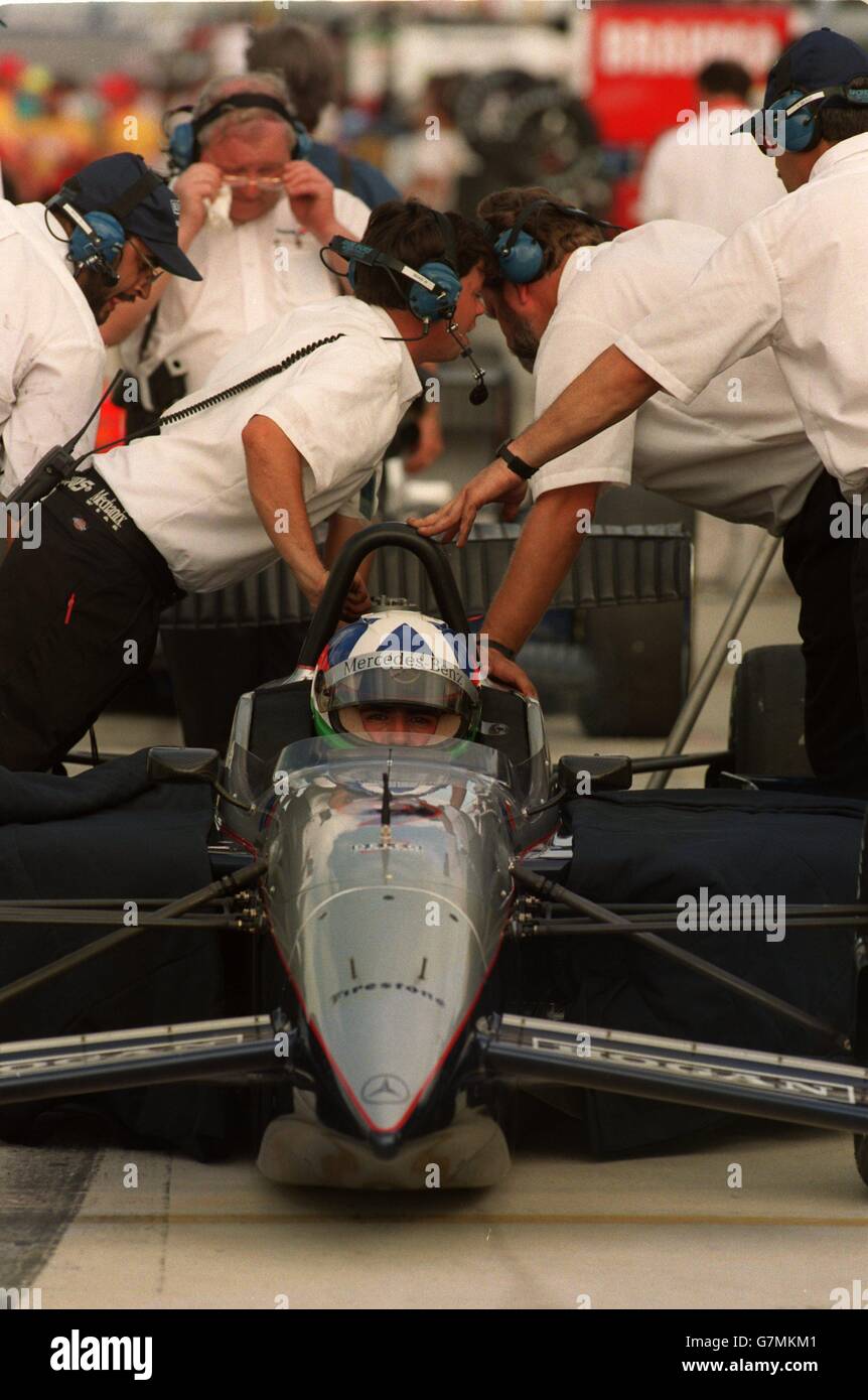 Team Hogan engineers work on Dario Franchitti's car during qualifying ...