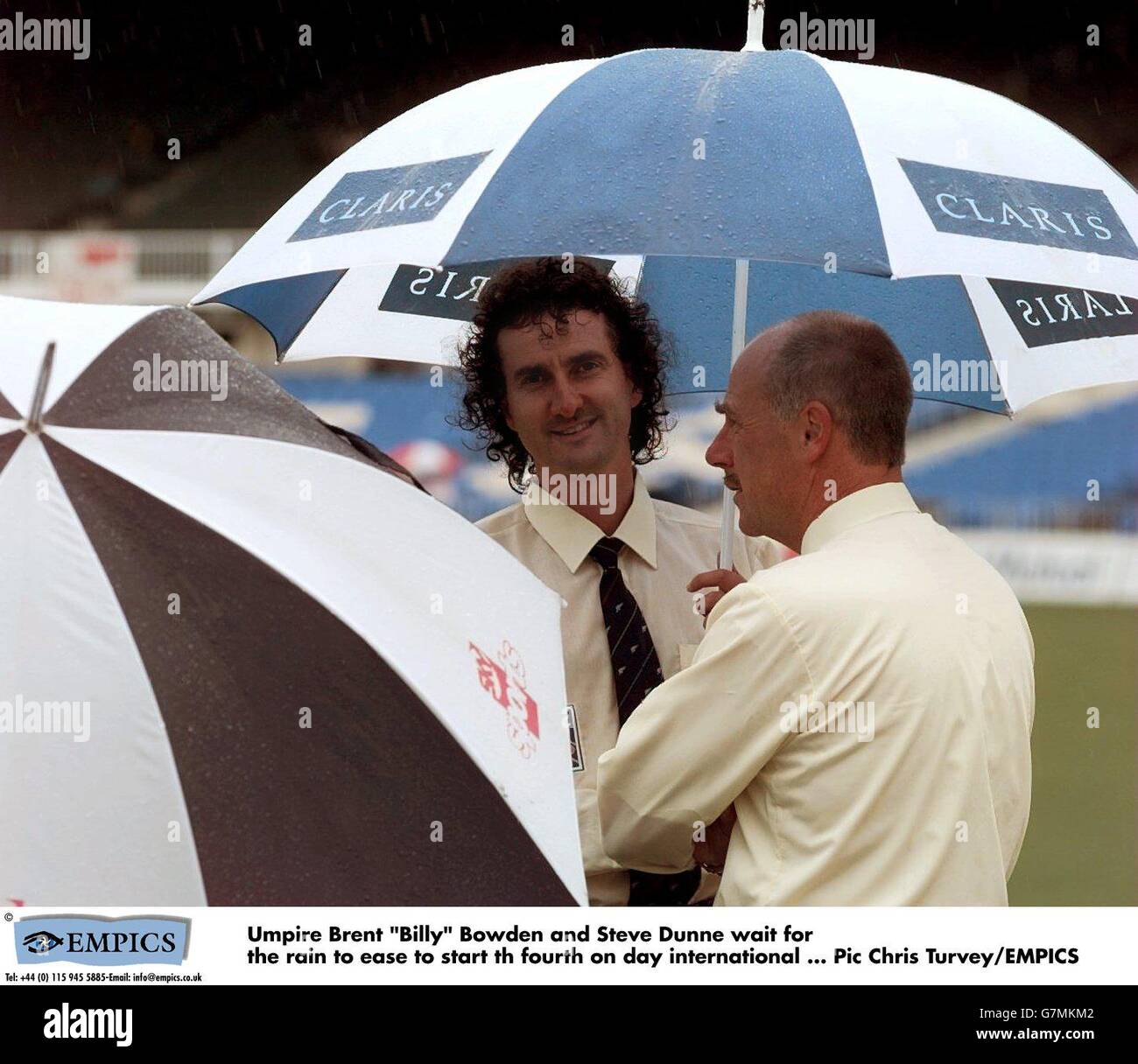 Umpire Brent Billy Bowden and Steve Dunne wait for the rain to ease to ...