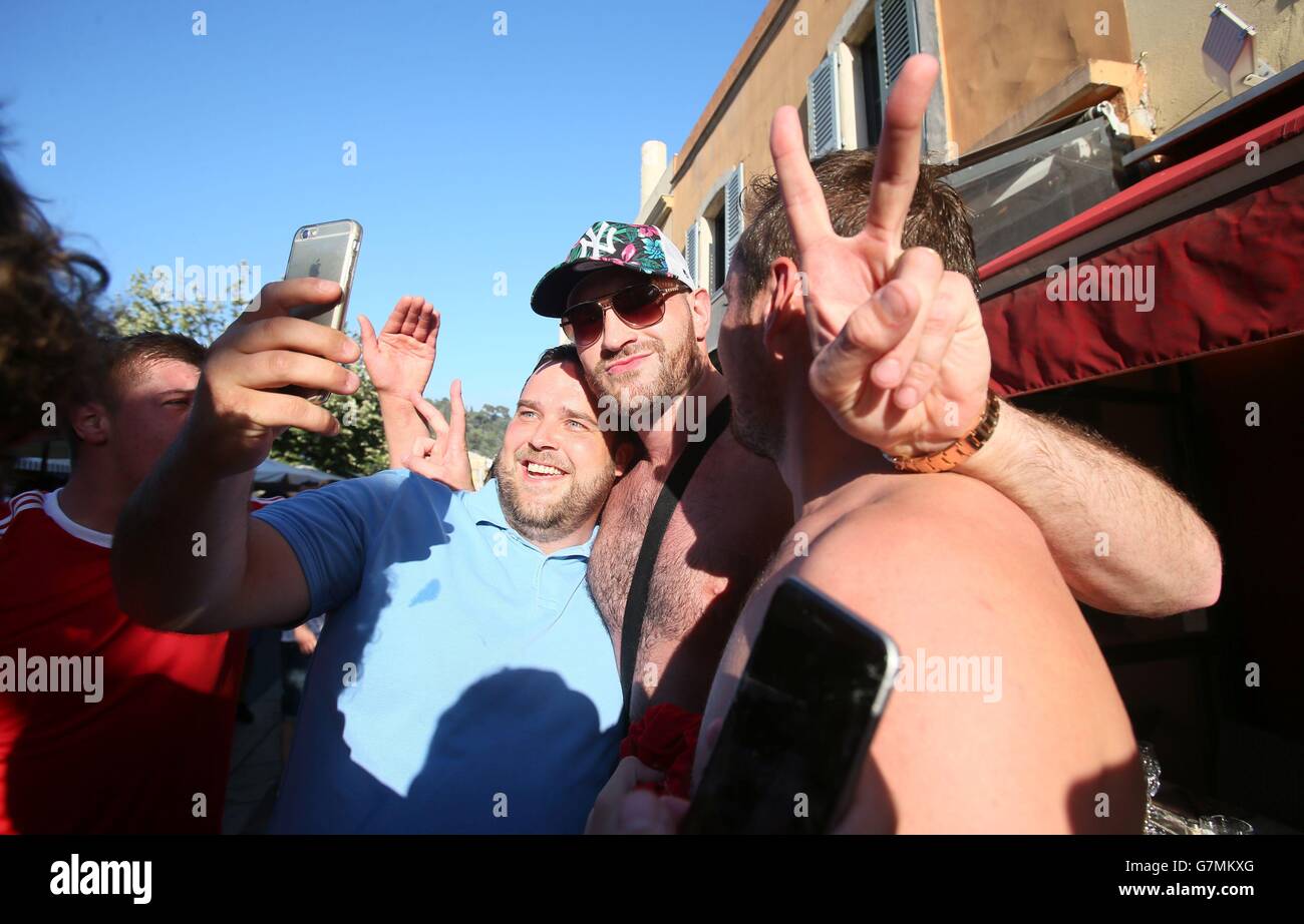 Boxer Tyson Fury poses for pictures with England supporters outside a ...