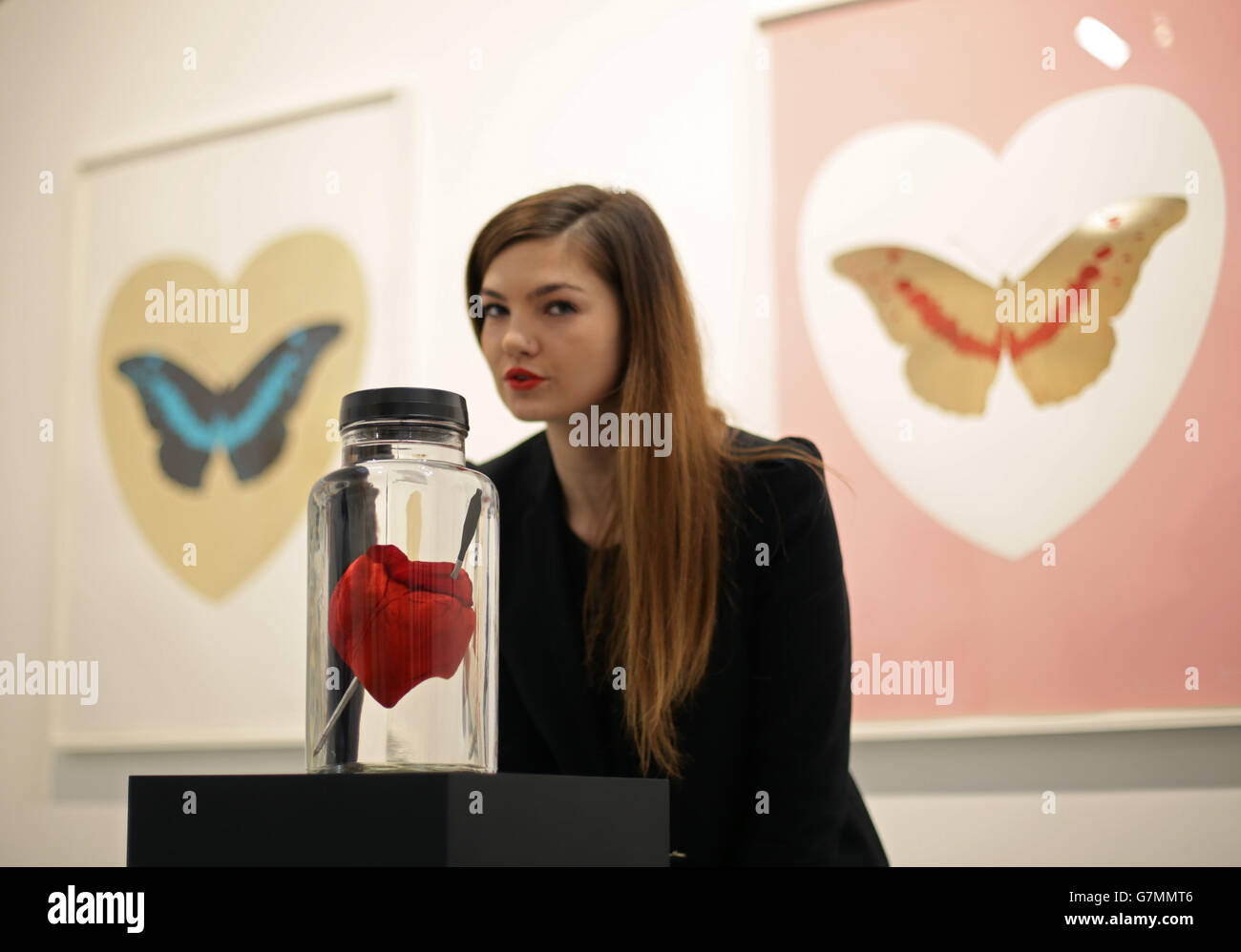 Gallery assistant Rachel Hunt with the piece 'Love Struck' - a resin ...