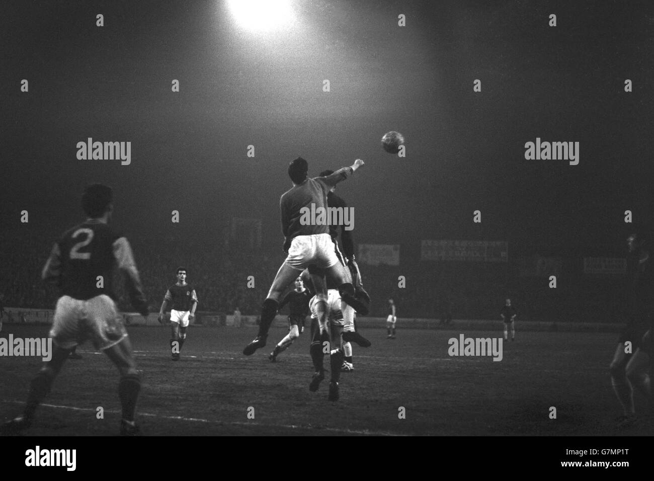 Aston Villa goalkeeper Colin Withers leaps to punch the ball from the ...