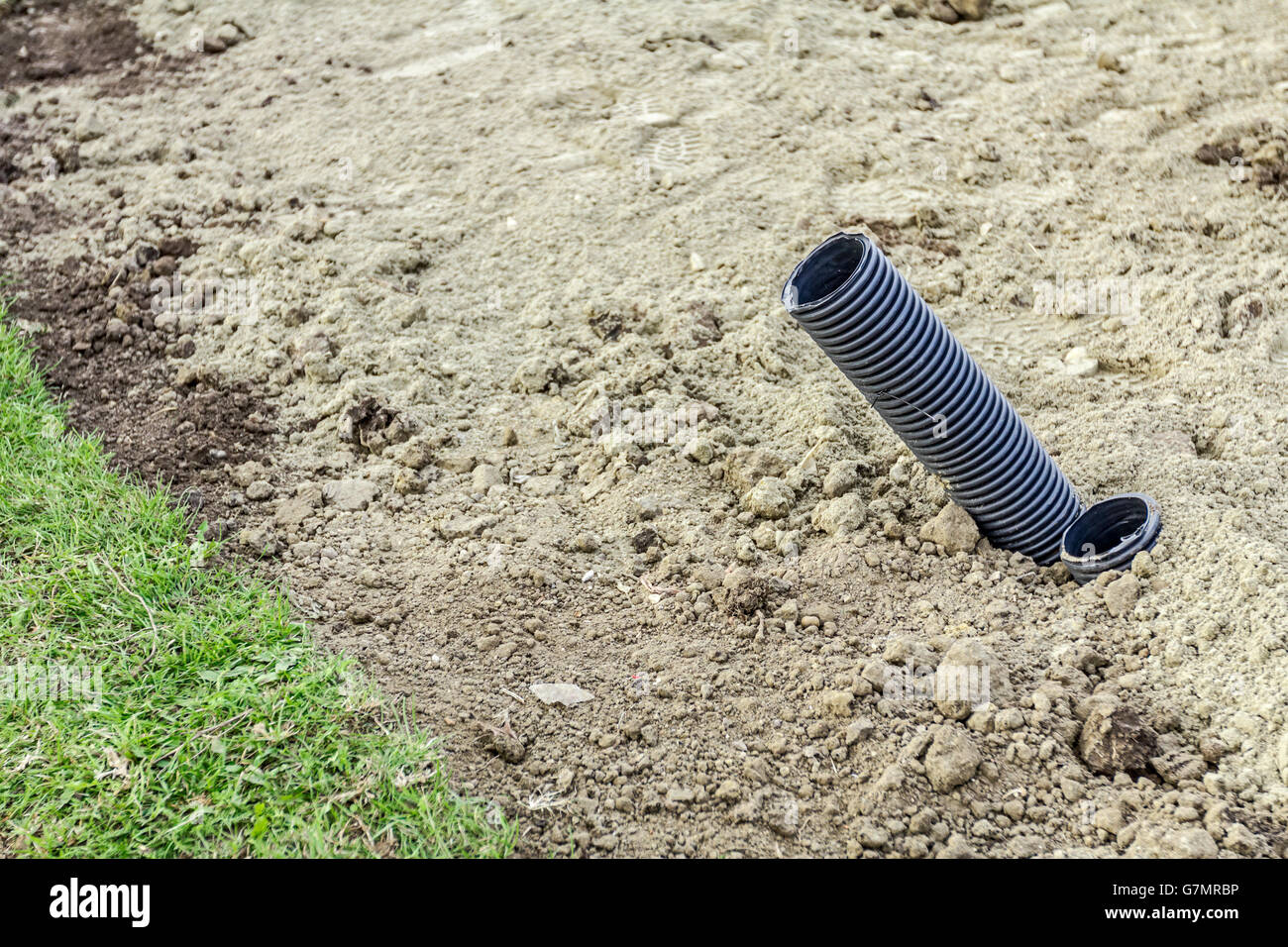 Black plastic corrugated pipes are coming out from the ground Stock ...