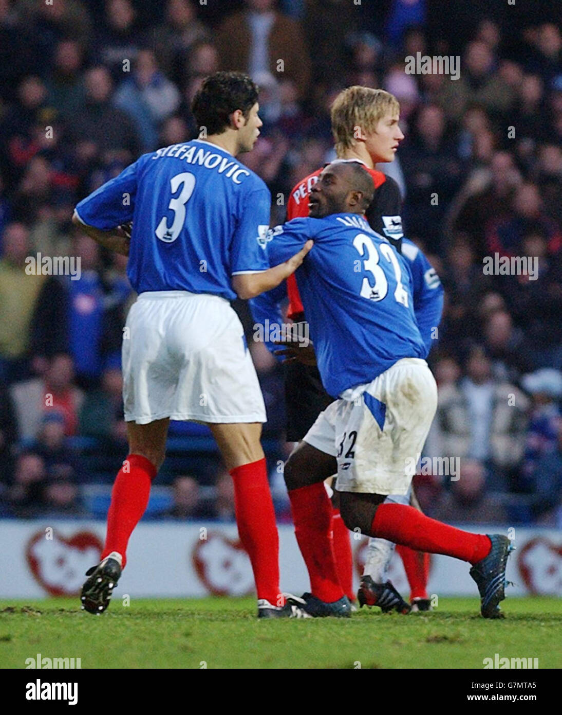 Portsmouth's Dejan Stefanovic drags his team mate Lomana Tresor LuaLua ...