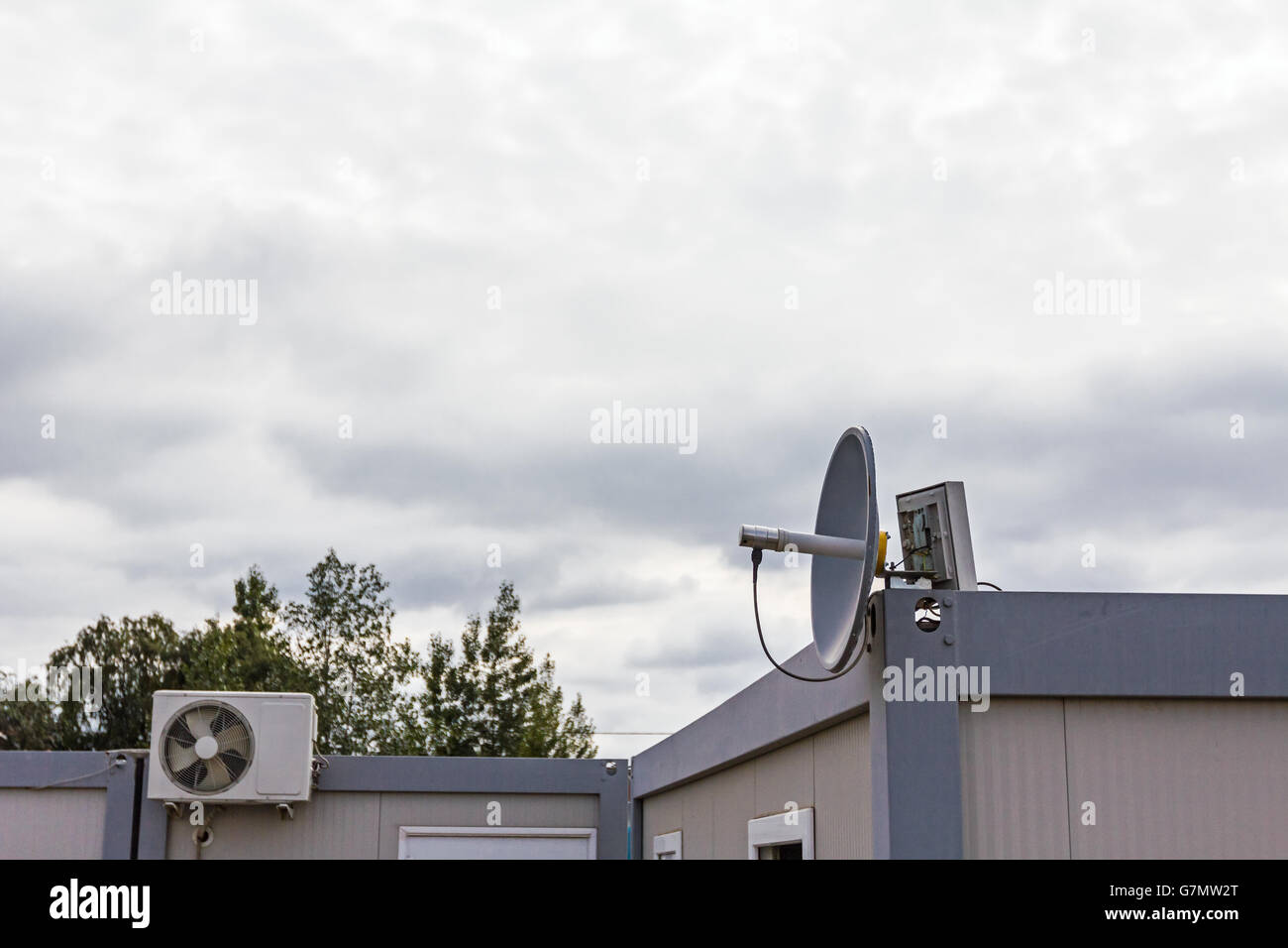 Small satellite dish receiver device is placed at rooftop container ...