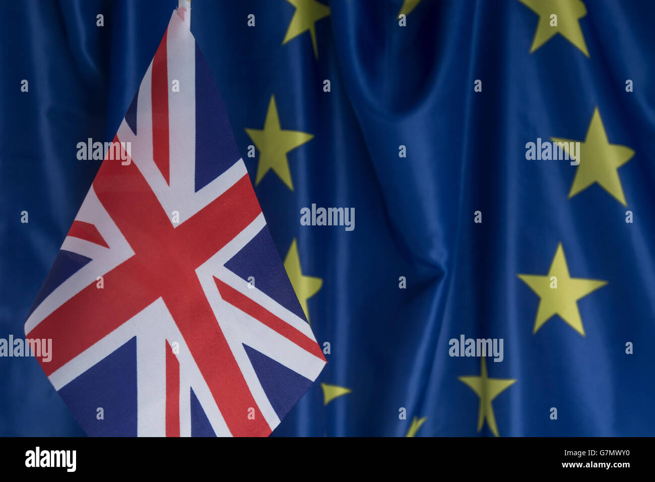 Brexit concept. Union Jack against crumpled EU European Community flag ...