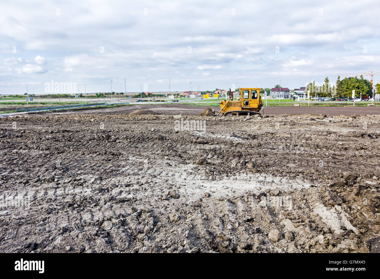 Earthmover with caterpillar is moving earth outdoors Stock Photo - Alamy