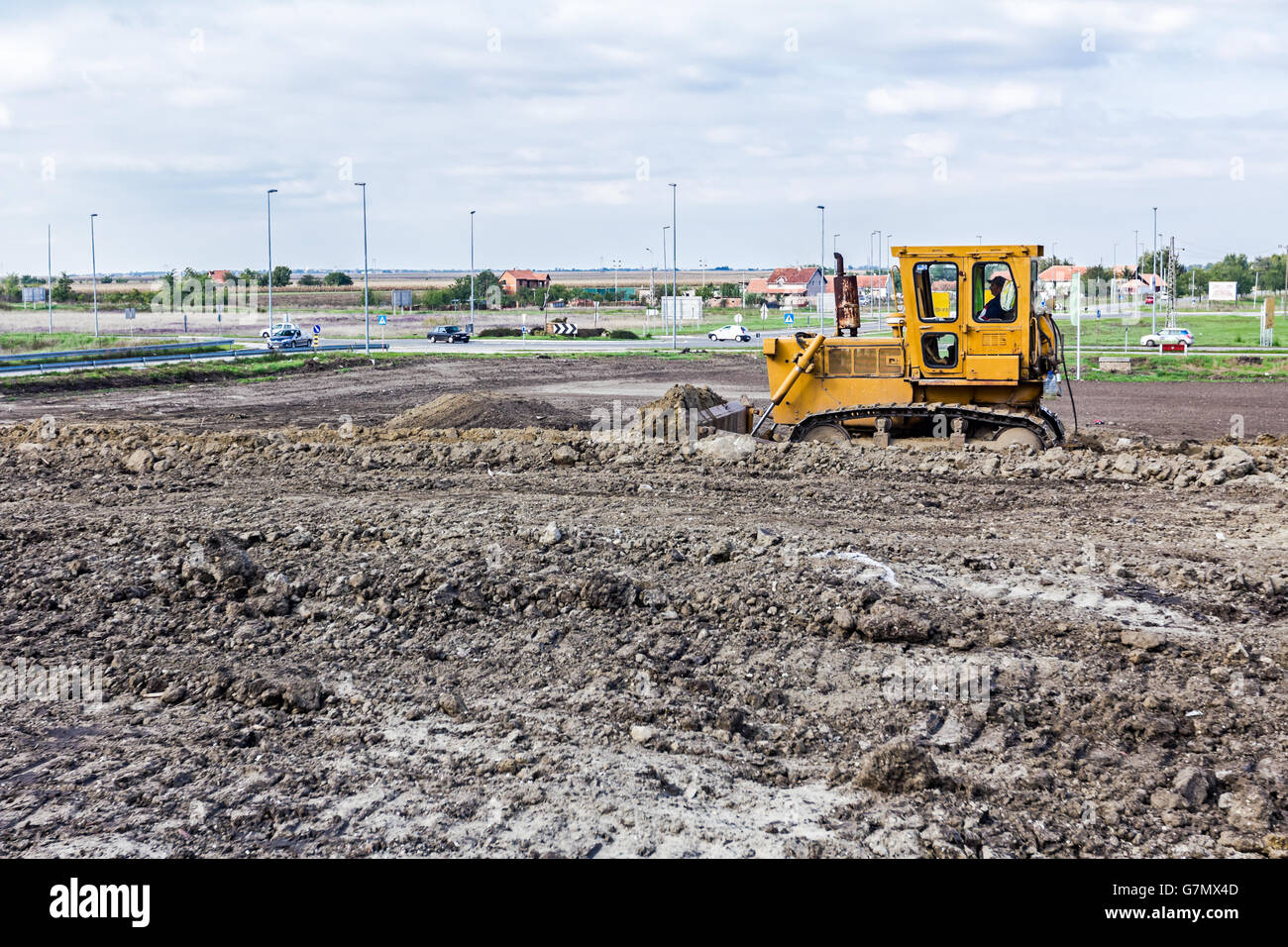 Earthmover with caterpillar is moving earth outdoors Stock Photo - Alamy