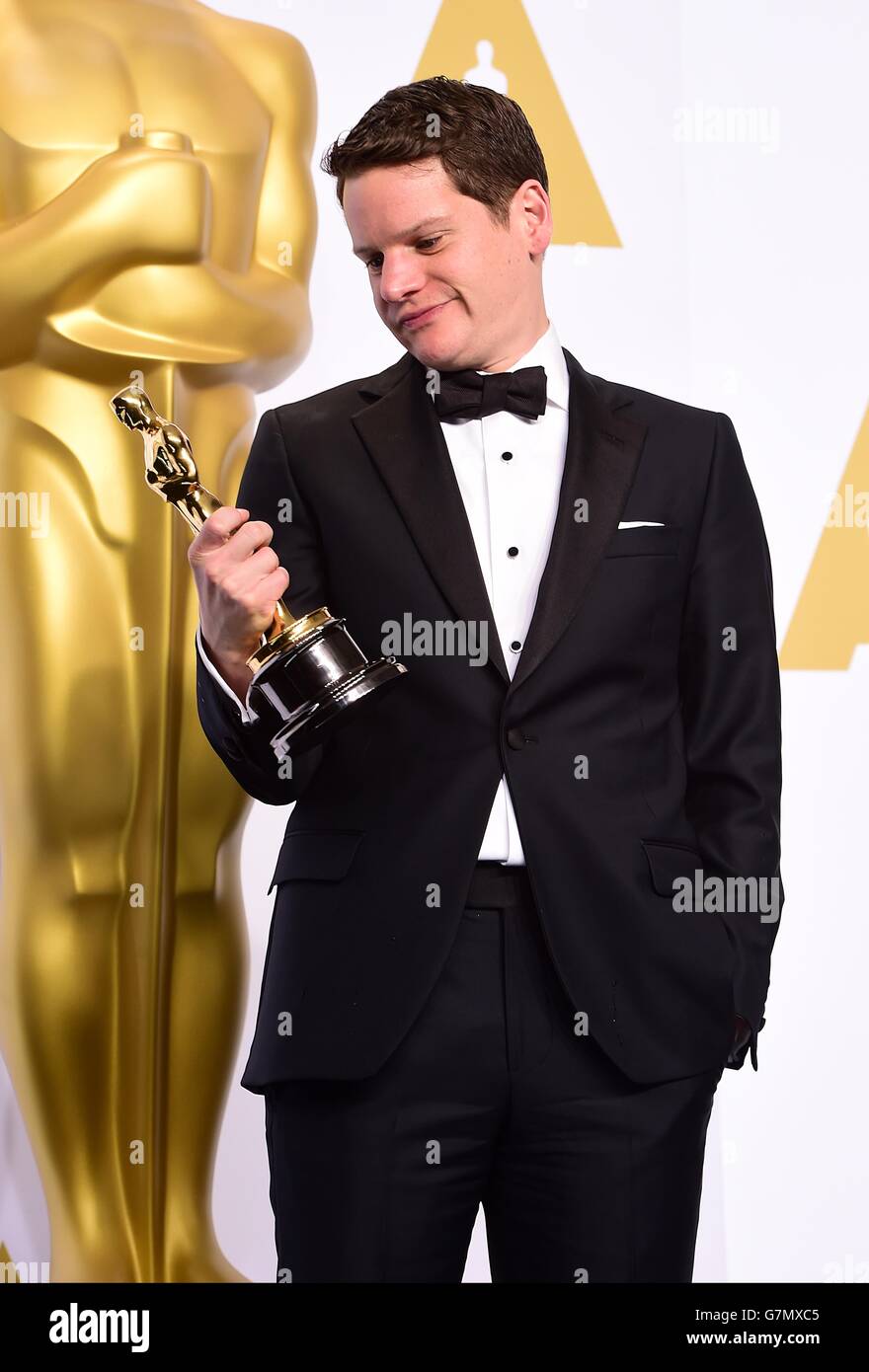 Graham Moore with the award for the best adapted screenplay for 'The ...
