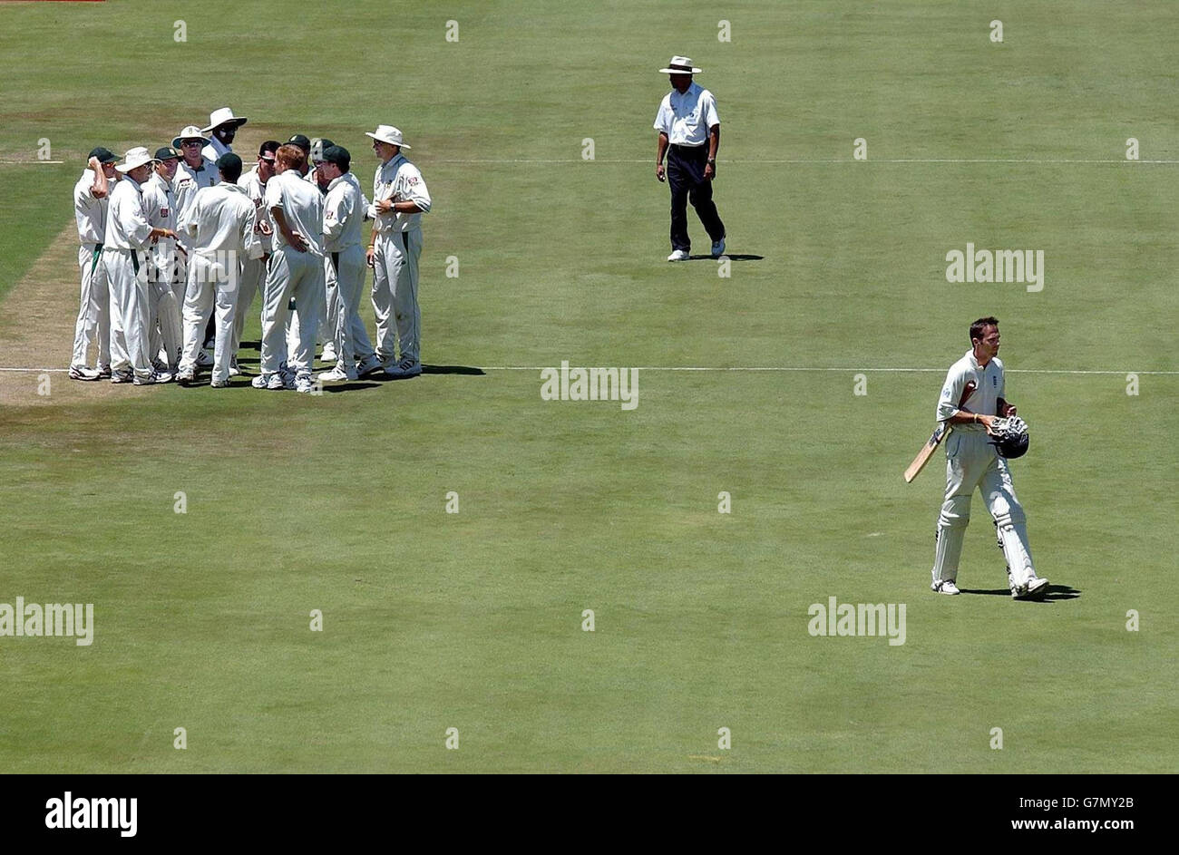England captain Michael Vaughan (right) leaves the field after being ...