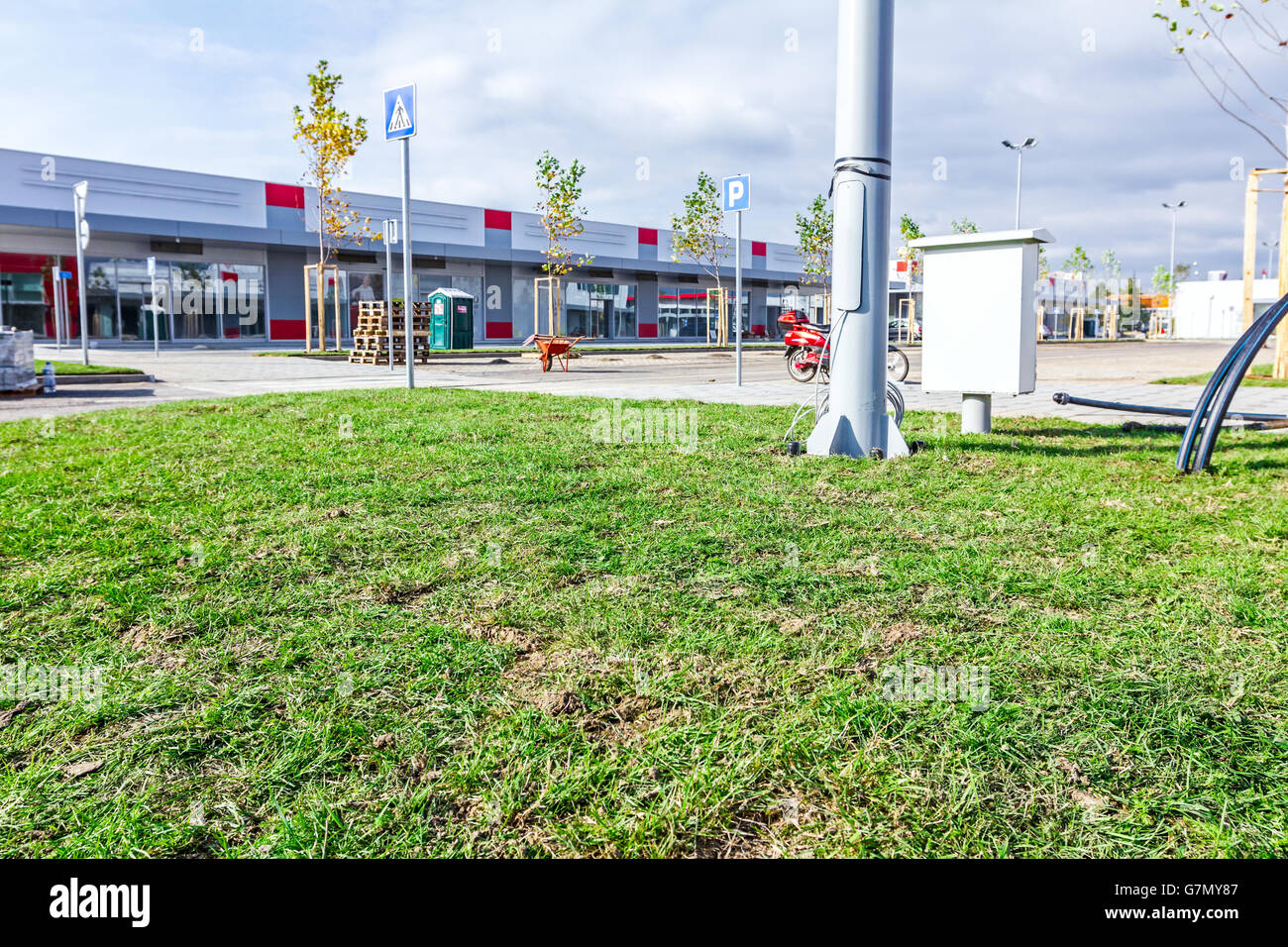 Unrolling grass, placed turf rolls on new lawn at shopping mall Stock ...