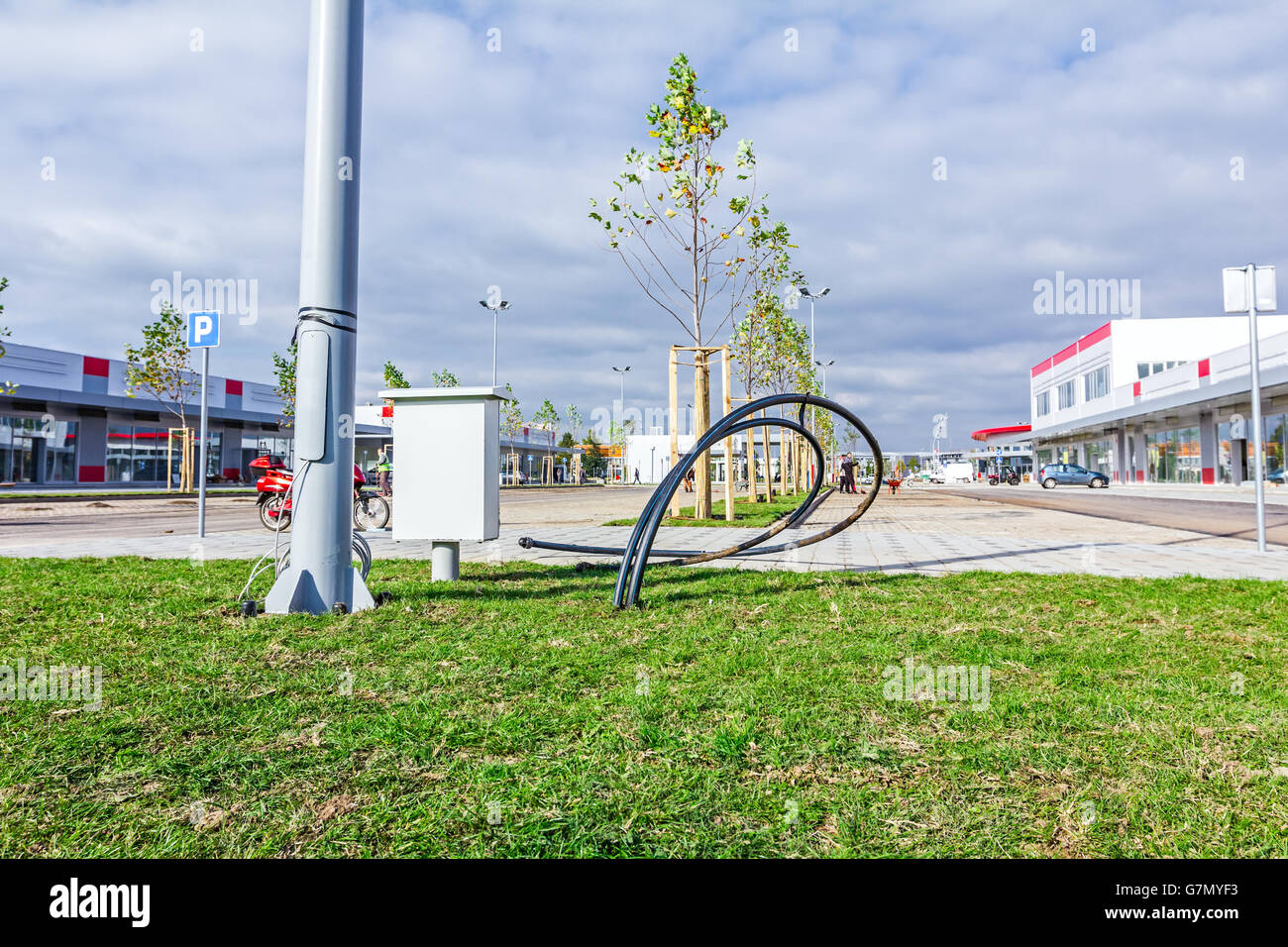 Unrolling grass, placed turf rolls on new lawn at shopping mall Stock ...