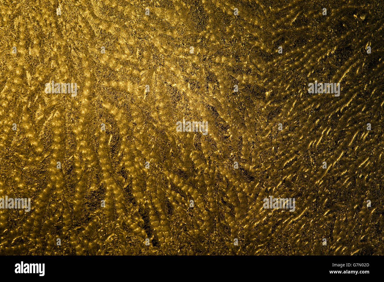 Car windshield with glass frozen with ice patterns at sunrise close-up ...