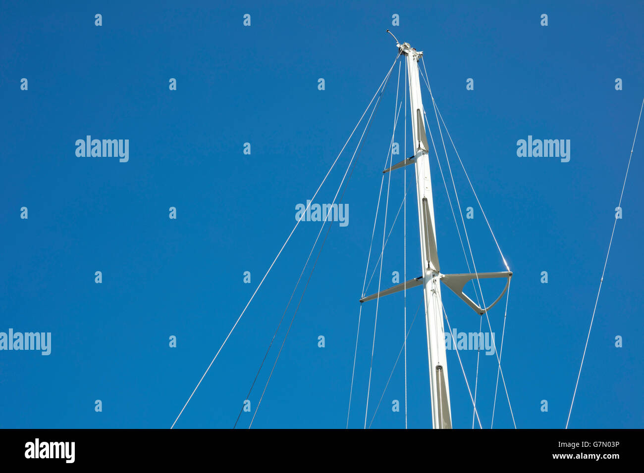 Detail of white masts of a boat with blue sky at the background Stock ...