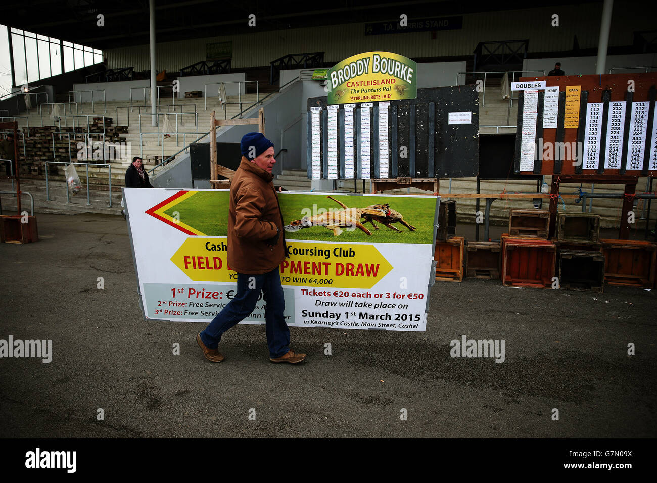 A man removes a sign for a raffle after the final day of the 90th ...