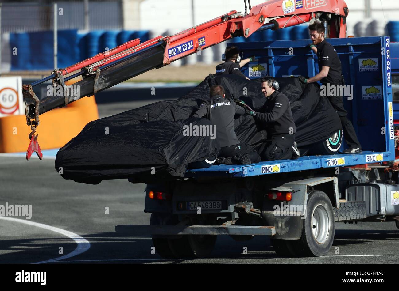 The Mercedes of Lewis Hamilton is carried back to the garage after ...