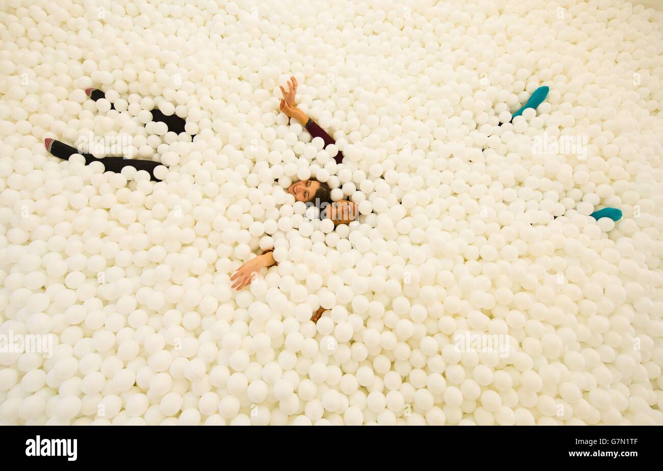 Visitors enjoy 'Jump In!', an adults-only ball pond holding over 80,000 ...